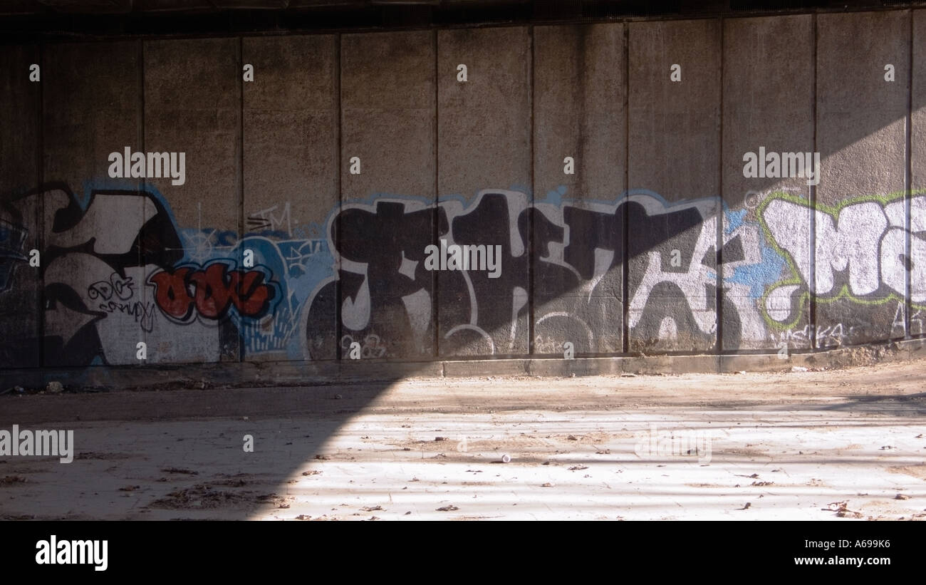 Graffiti on concrete wall under bridge Stock Photo - Alamy
