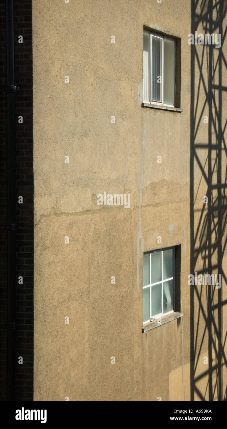 Shadow of tower crane on side of cement rendered building Stock Photo ...