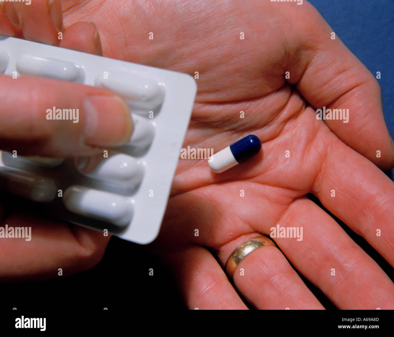 Placing a capsule in the palm of a hand from a sealed pack Stock Photo ...
