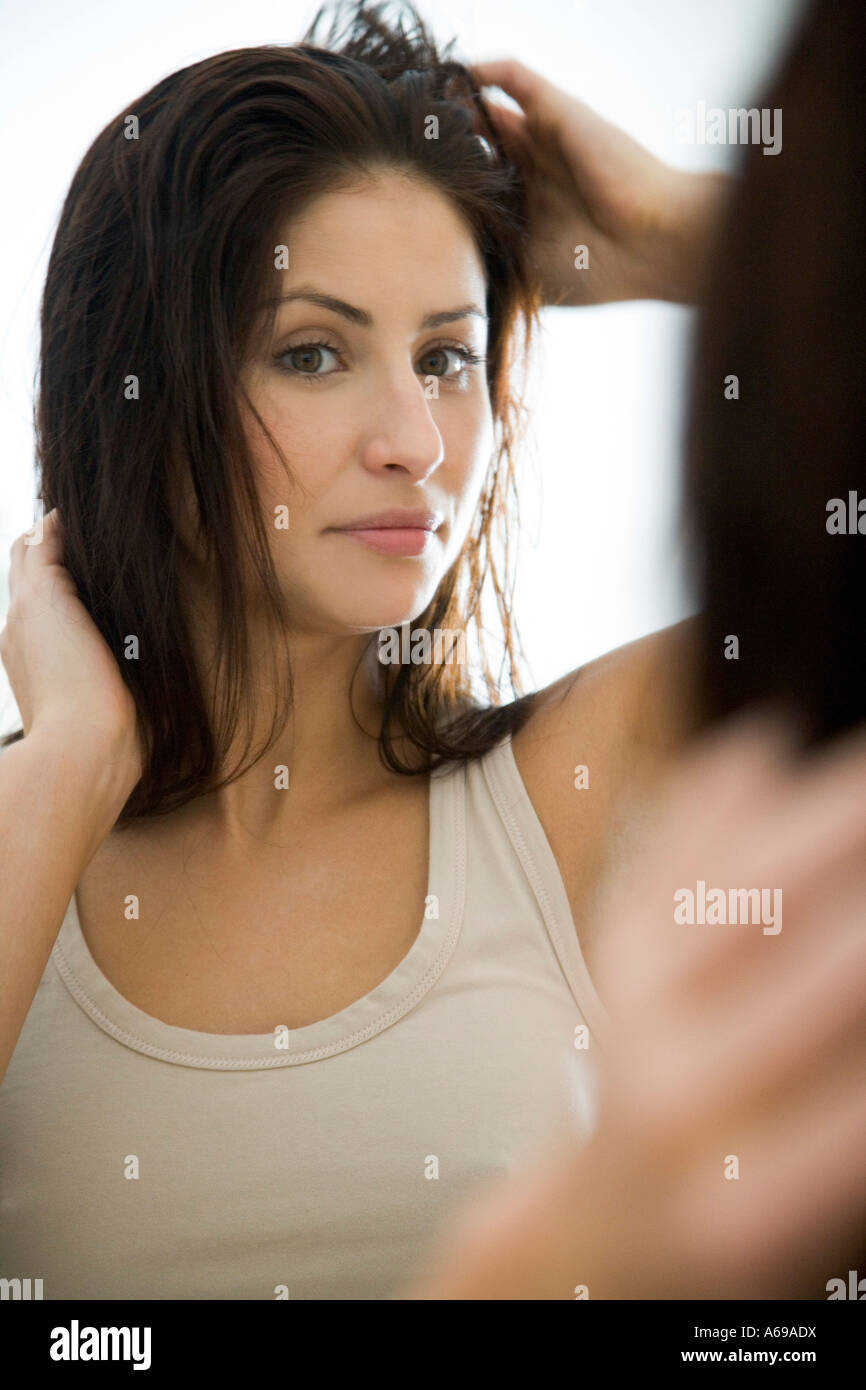 woman looking in the mirror Stock Photo - Alamy