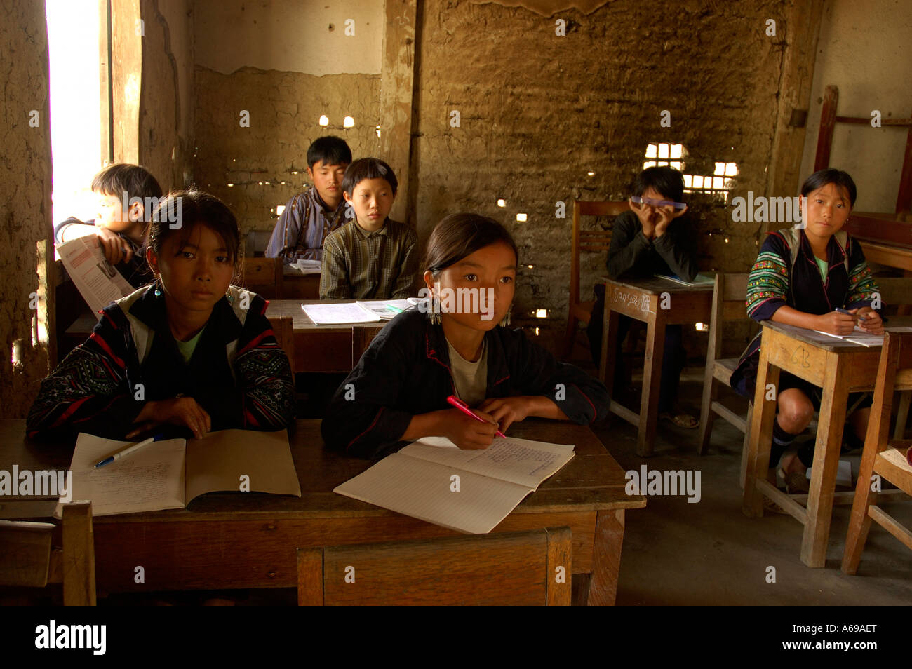 Black Hmong children dressed in traditional clothing study in the small ...