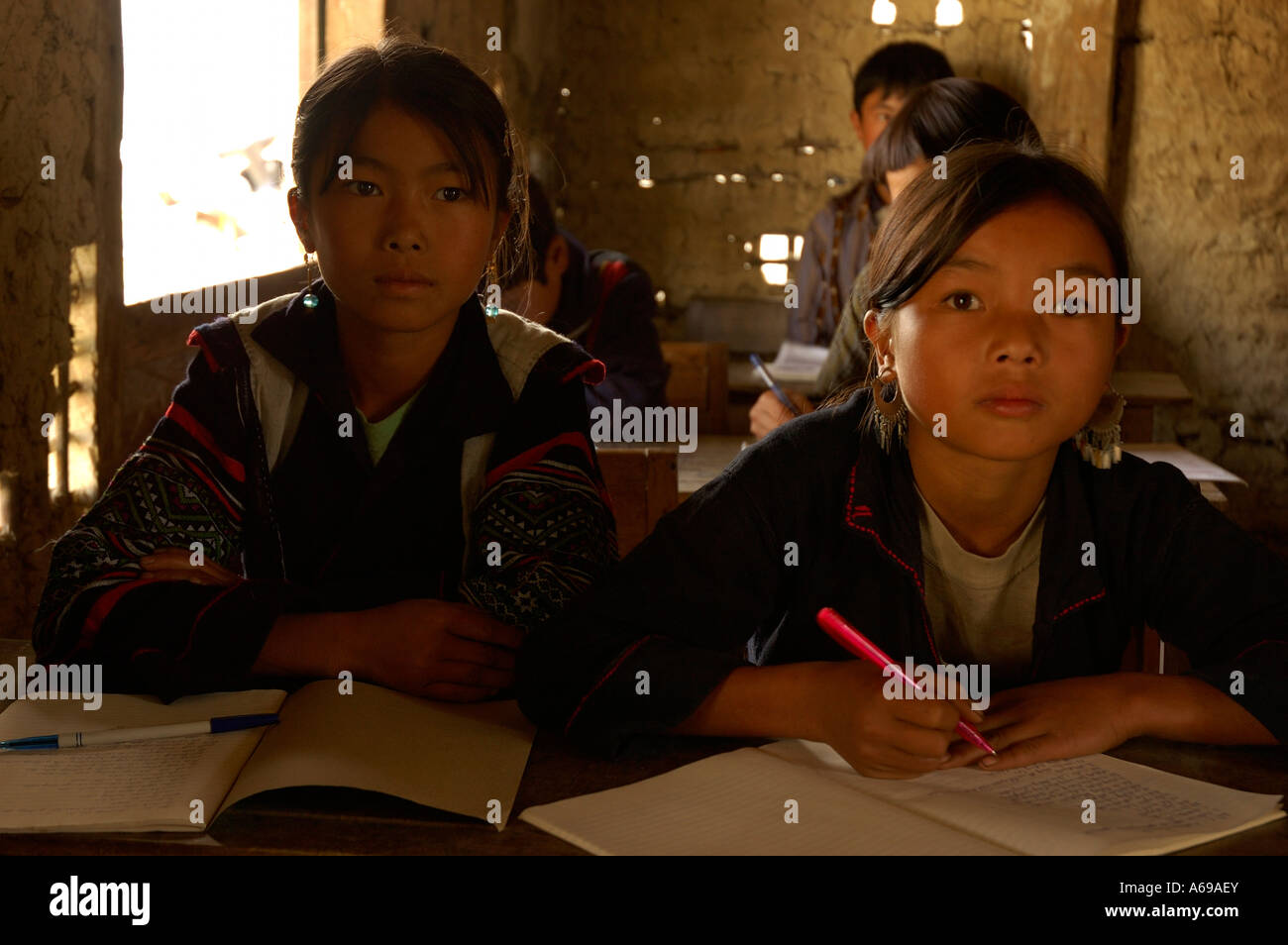 Black Hmong children dressed in traditional clothing study in the small ...