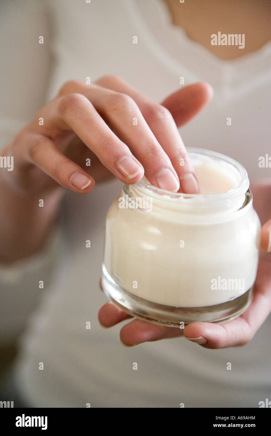 young woman applying cream Stock Photo - Alamy