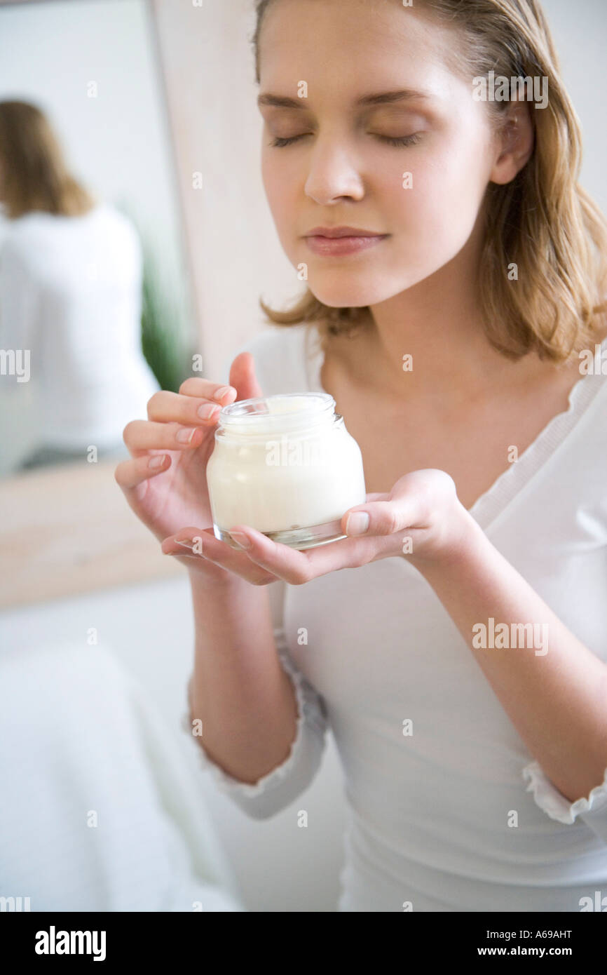 young woman applying cream Stock Photo - Alamy
