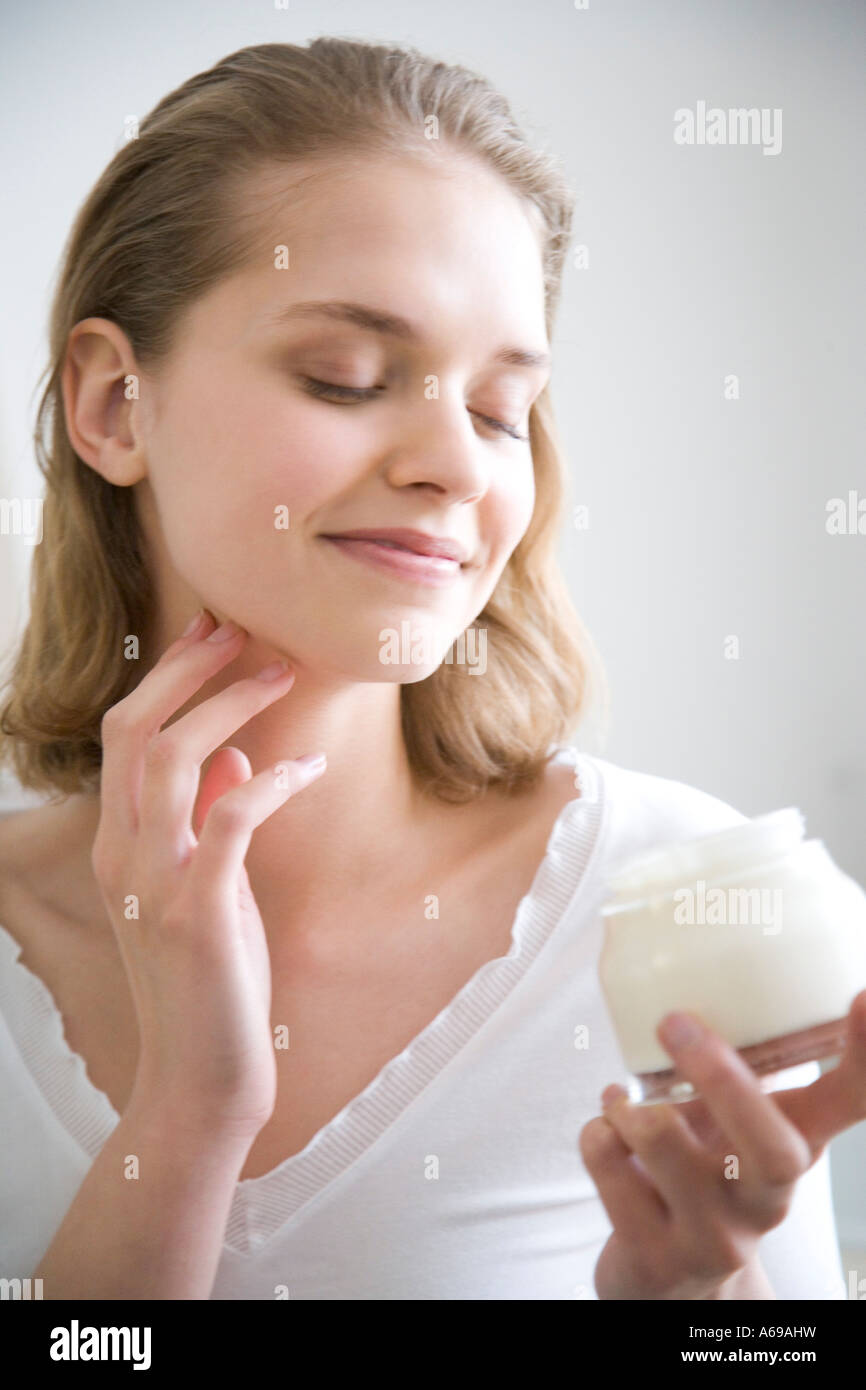 young woman applying cream Stock Photo - Alamy