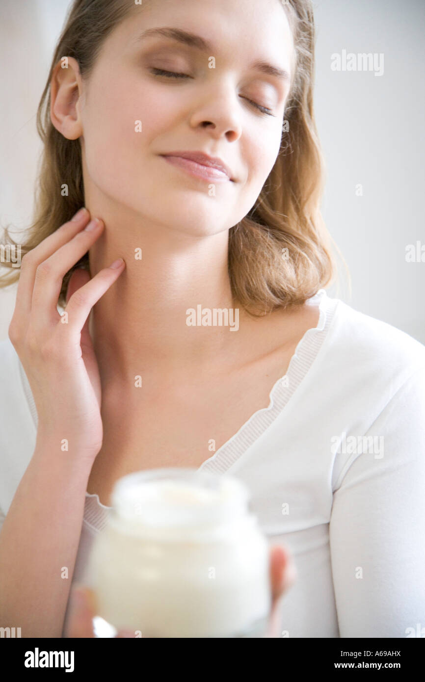 young woman applying cream Stock Photo - Alamy