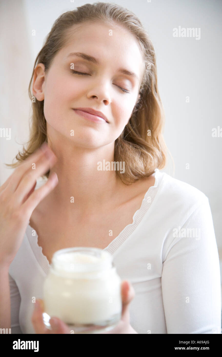 young woman applying cream Stock Photo - Alamy