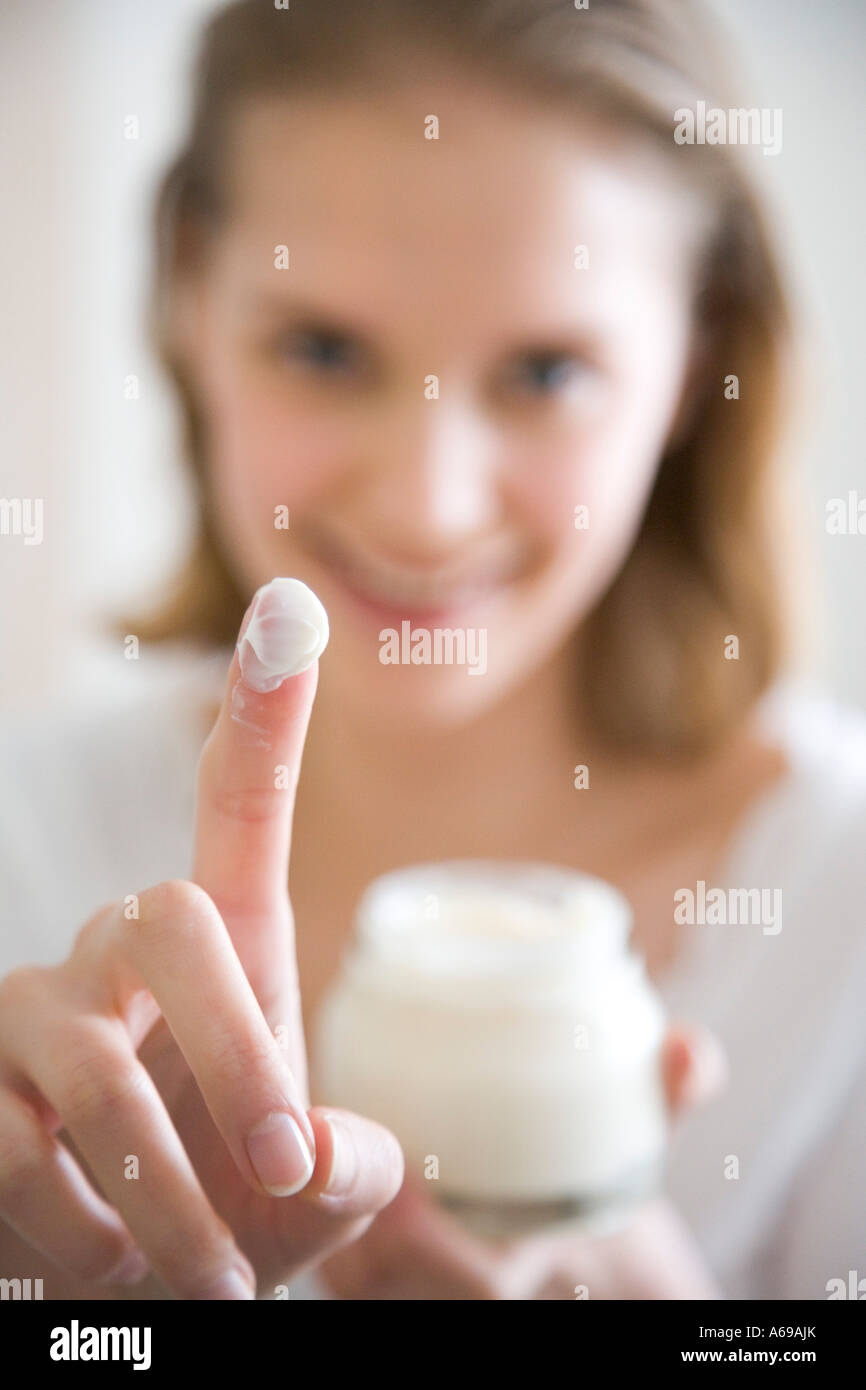 young woman applying cream Stock Photo - Alamy