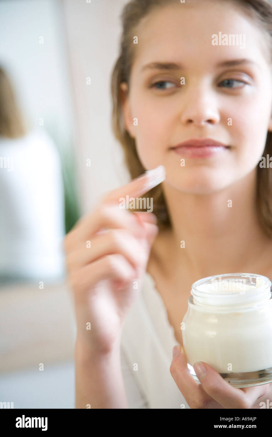 young woman applying cream Stock Photo - Alamy