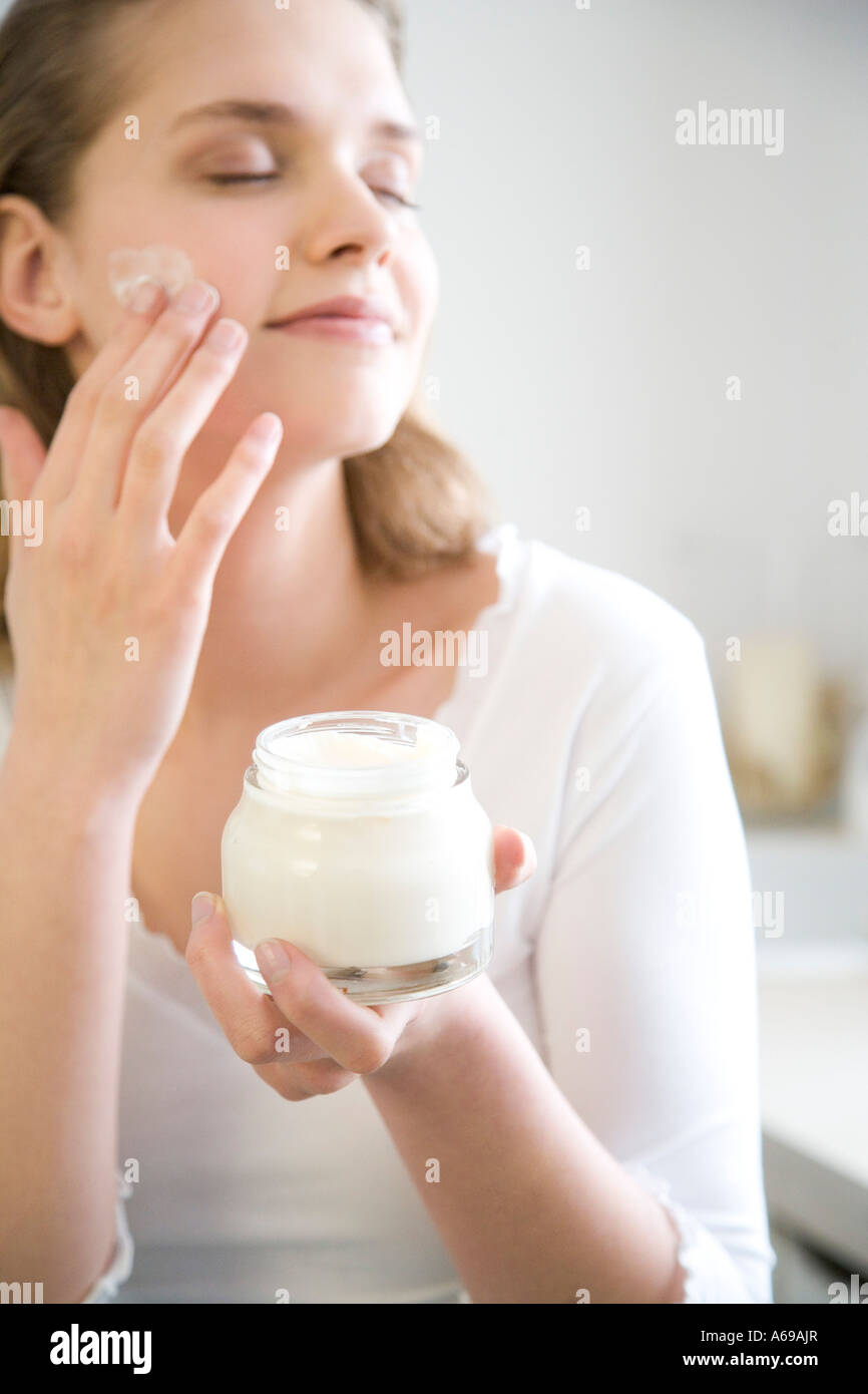 young woman applying cream Stock Photo - Alamy