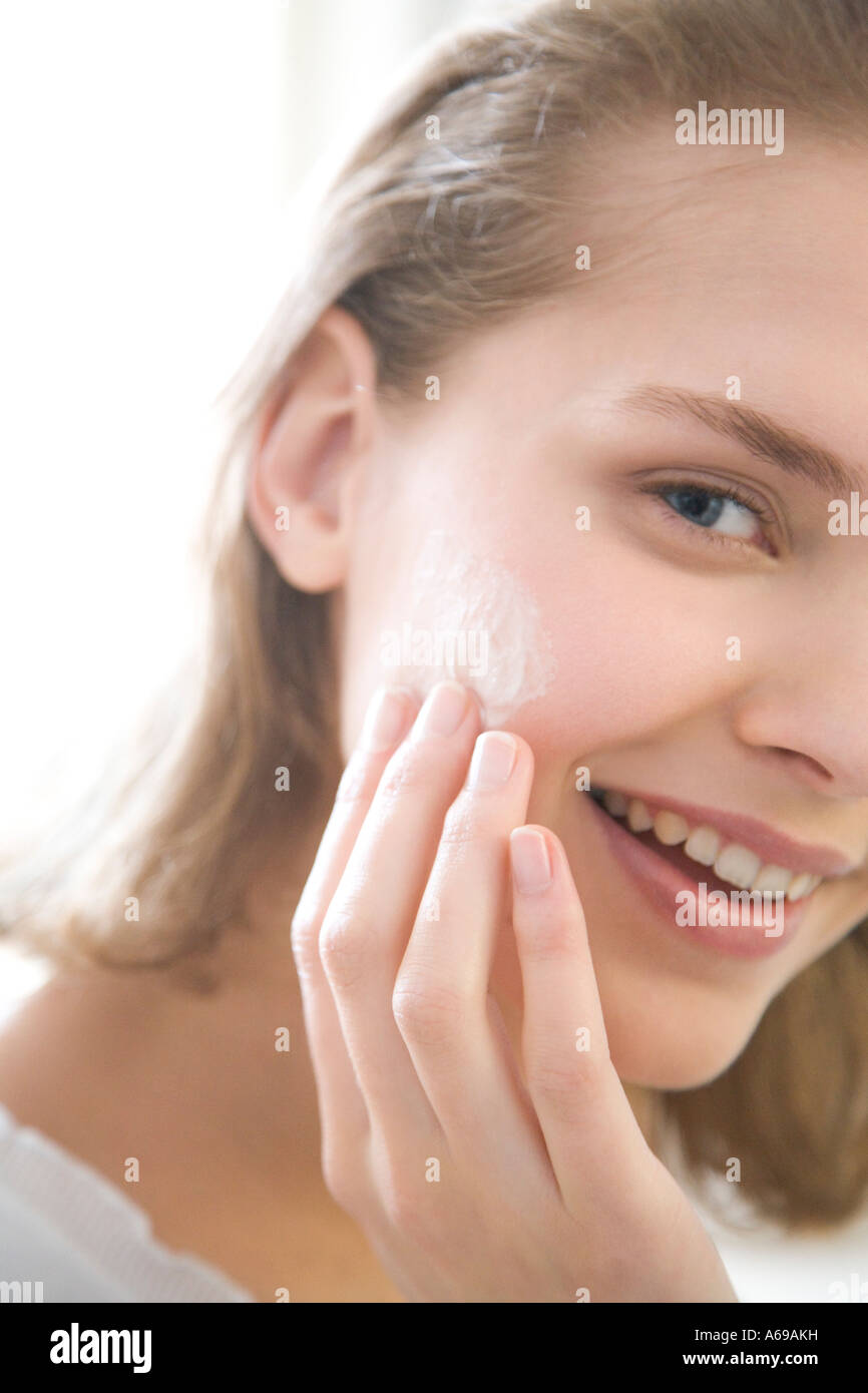 young woman applying cream Stock Photo - Alamy