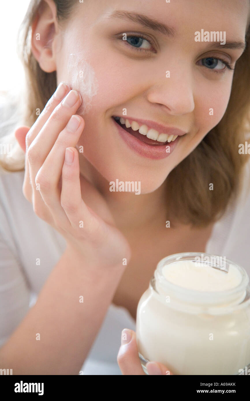 young woman applying cream Stock Photo - Alamy