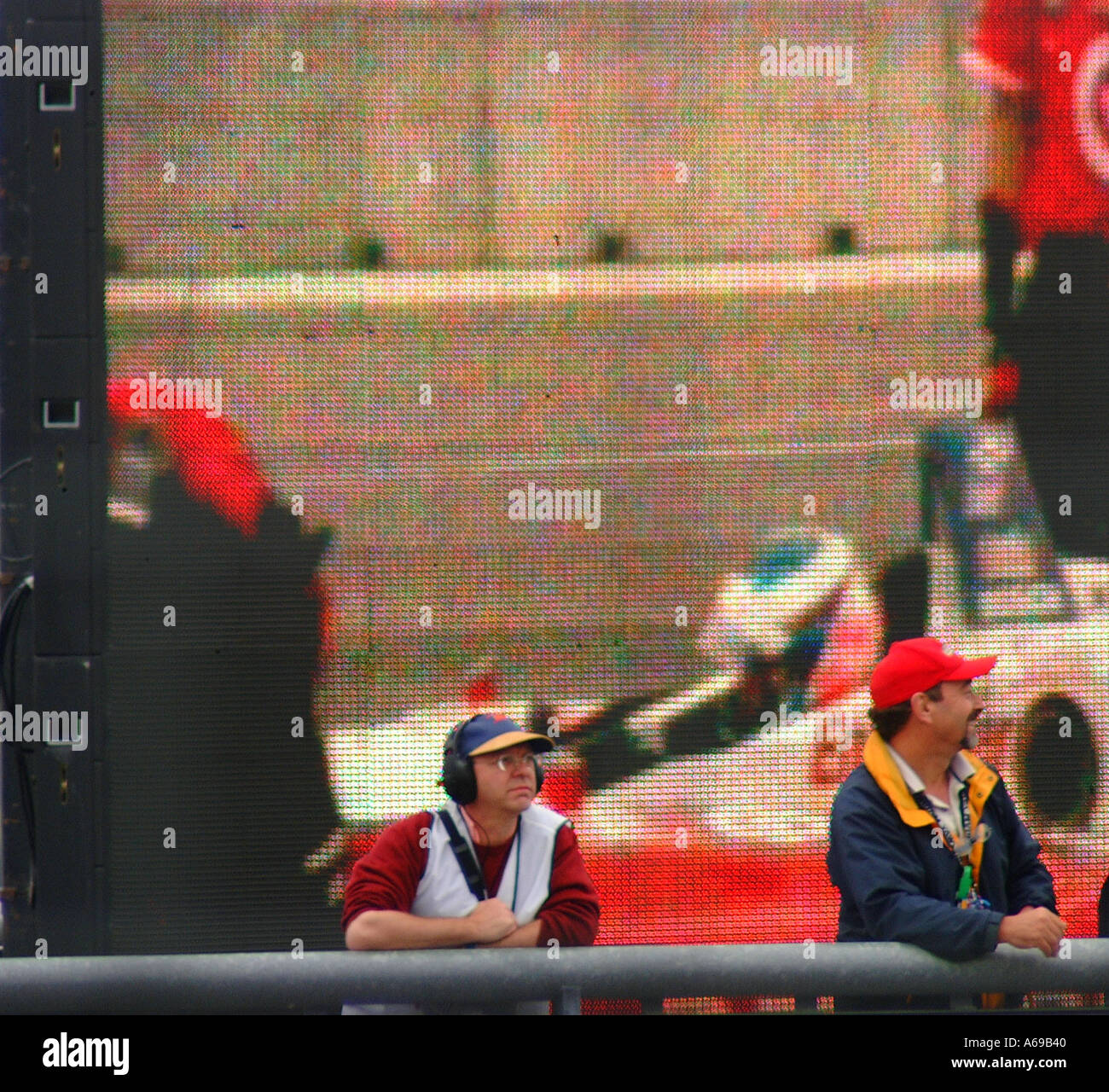 motorracing spectators in front of big screen Stock Photo - Alamy
