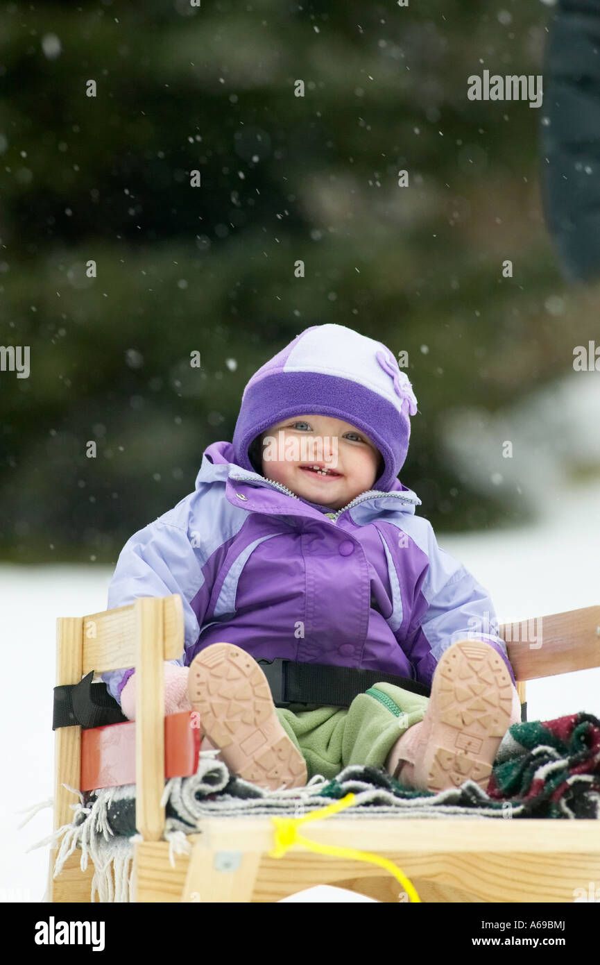 todler sitting on sled Stock Photo - Alamy