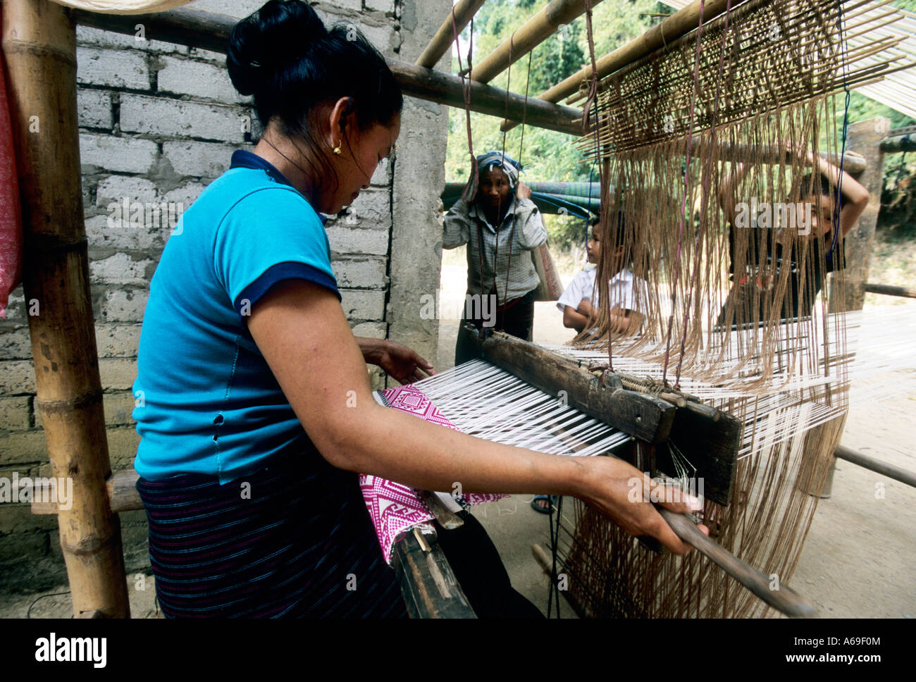 Local woman sitting at a traditional weaving loom. Laos Stock Photo - Alamy
