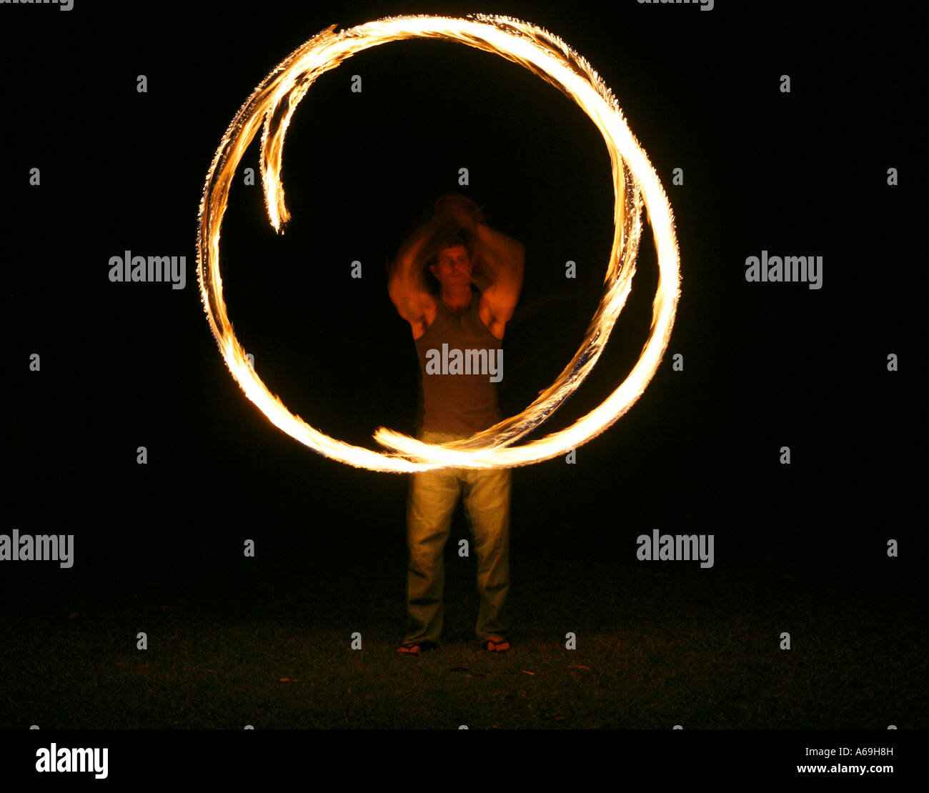 Man twirling fire sticks at festival in Australia Stock Photo - Alamy