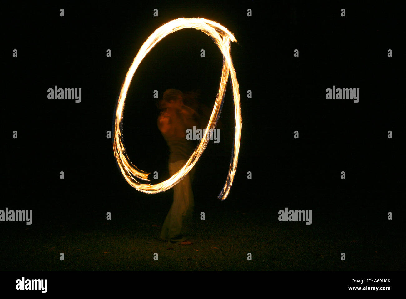 Man twirling fire sticks at festival in Australia Stock Photo - Alamy