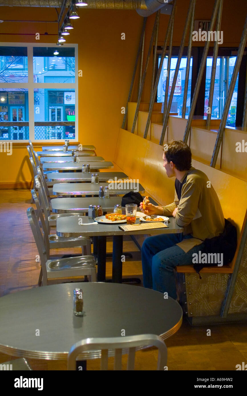 man sitting alone in restaurant looking out window Stock Photo - Alamy