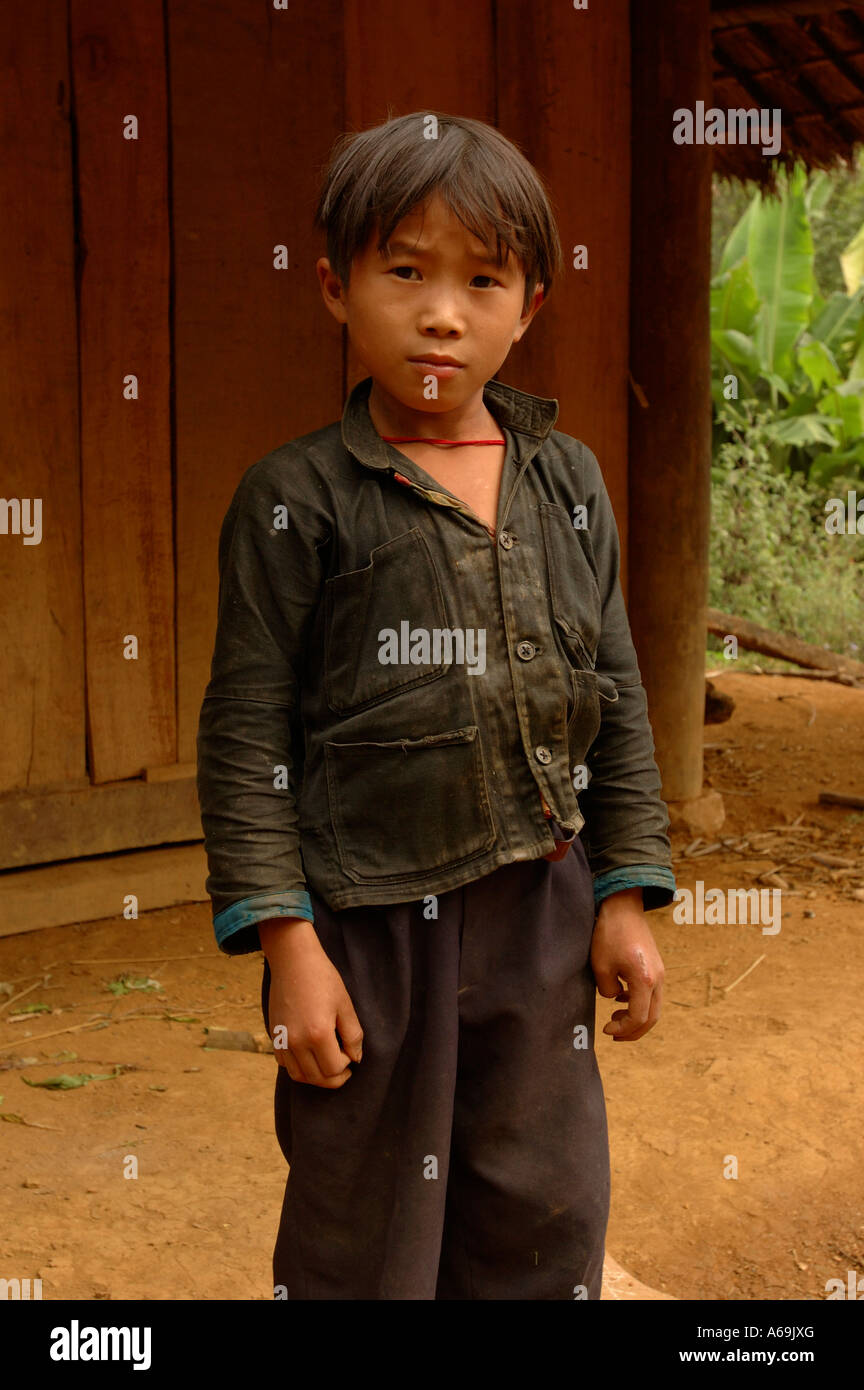 A Blue Hmong indigenous boy wearing traditional cloth proudly stands in ...