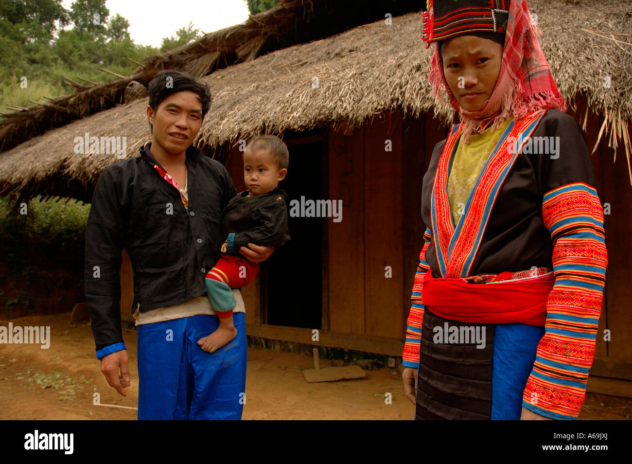 A Blue Hmong indigenous family wearing traditional cloth proudly poses ...