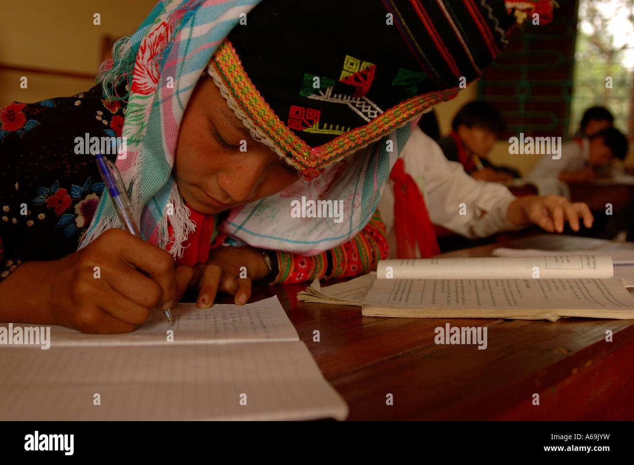A Blue Hmong indigenous girl dressed in colorful traditional clothing ...