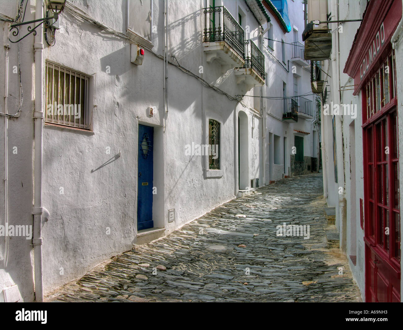 Late afternoon sun lights one of many picturesque streets in Cadaques ...