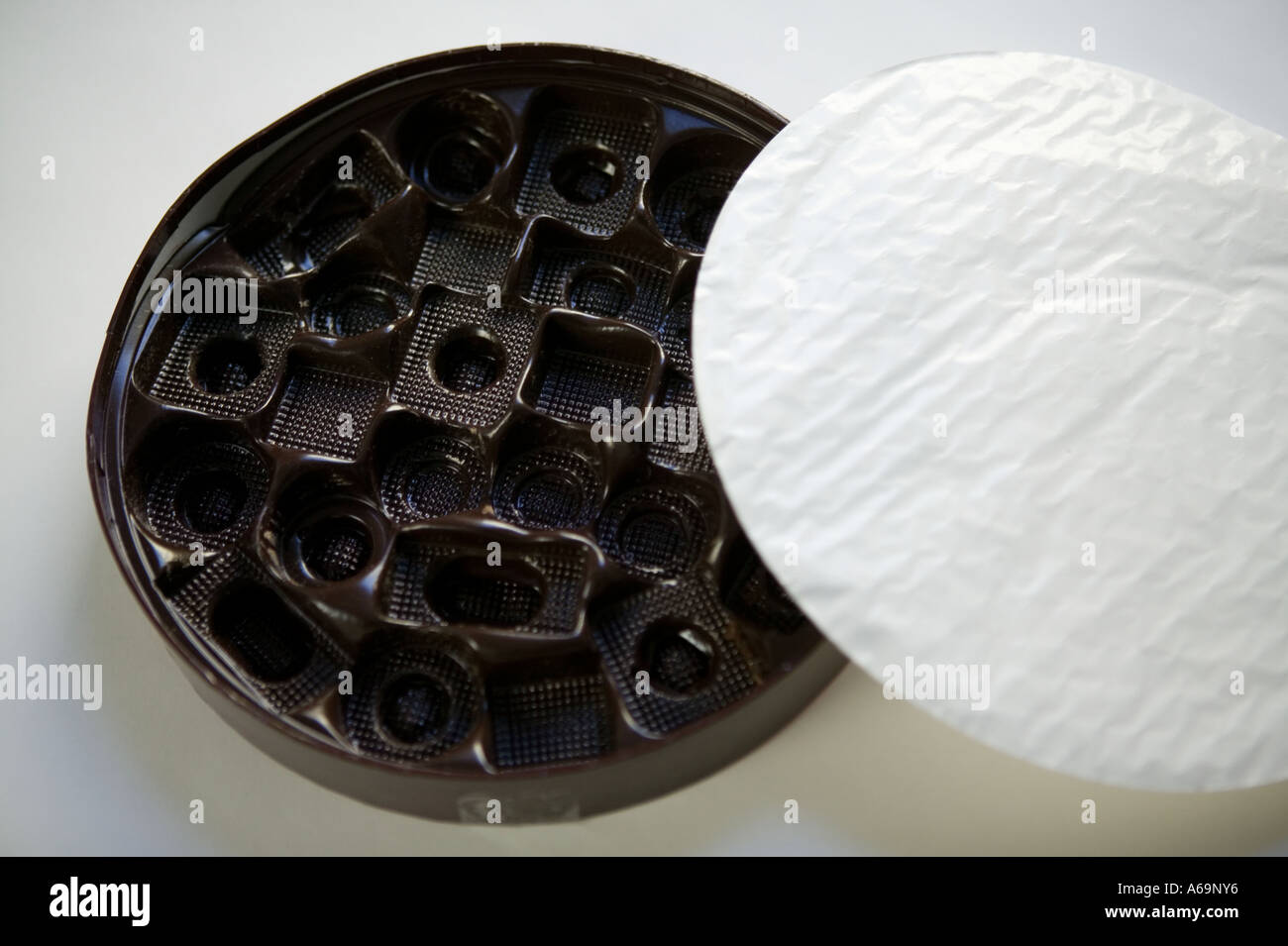 Studio shot of an empty plastic box of chocolates on a plain white ...