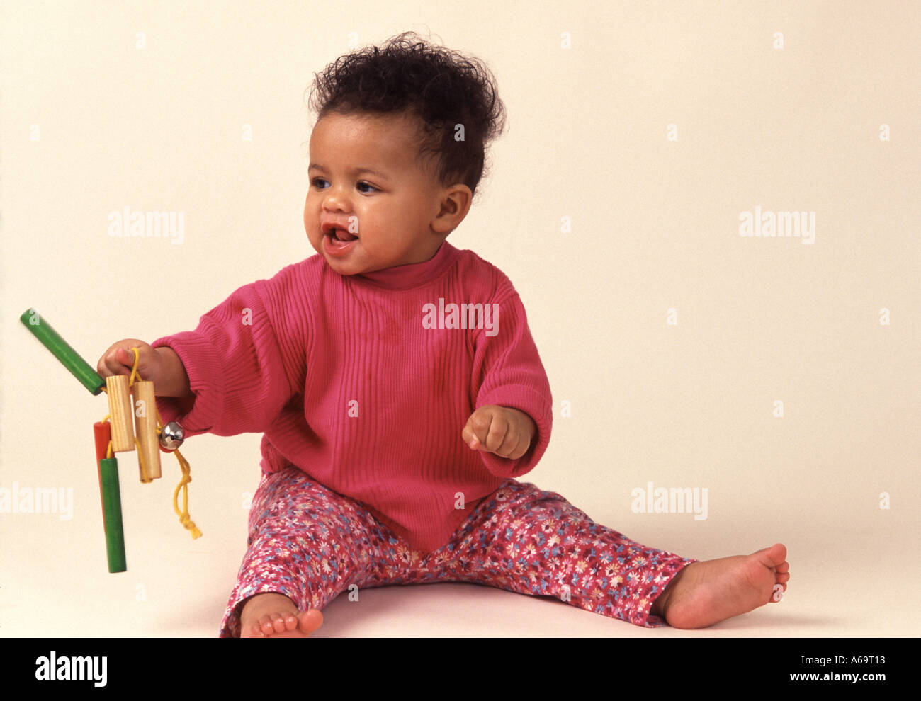 Baby girl playing with a toy Stock Photo - Alamy