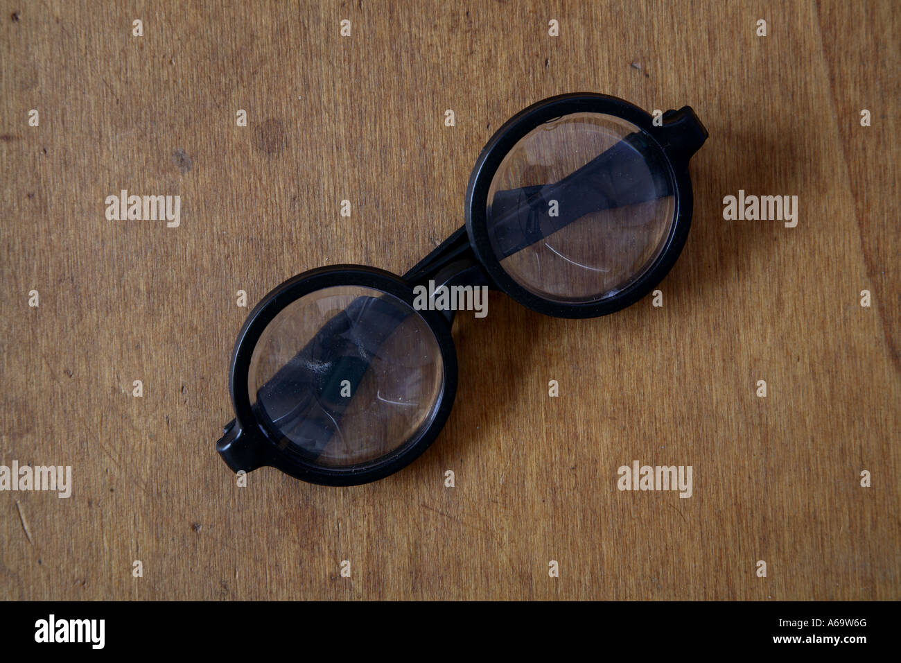 plastic reading glasses on wood Stock Photo - Alamy