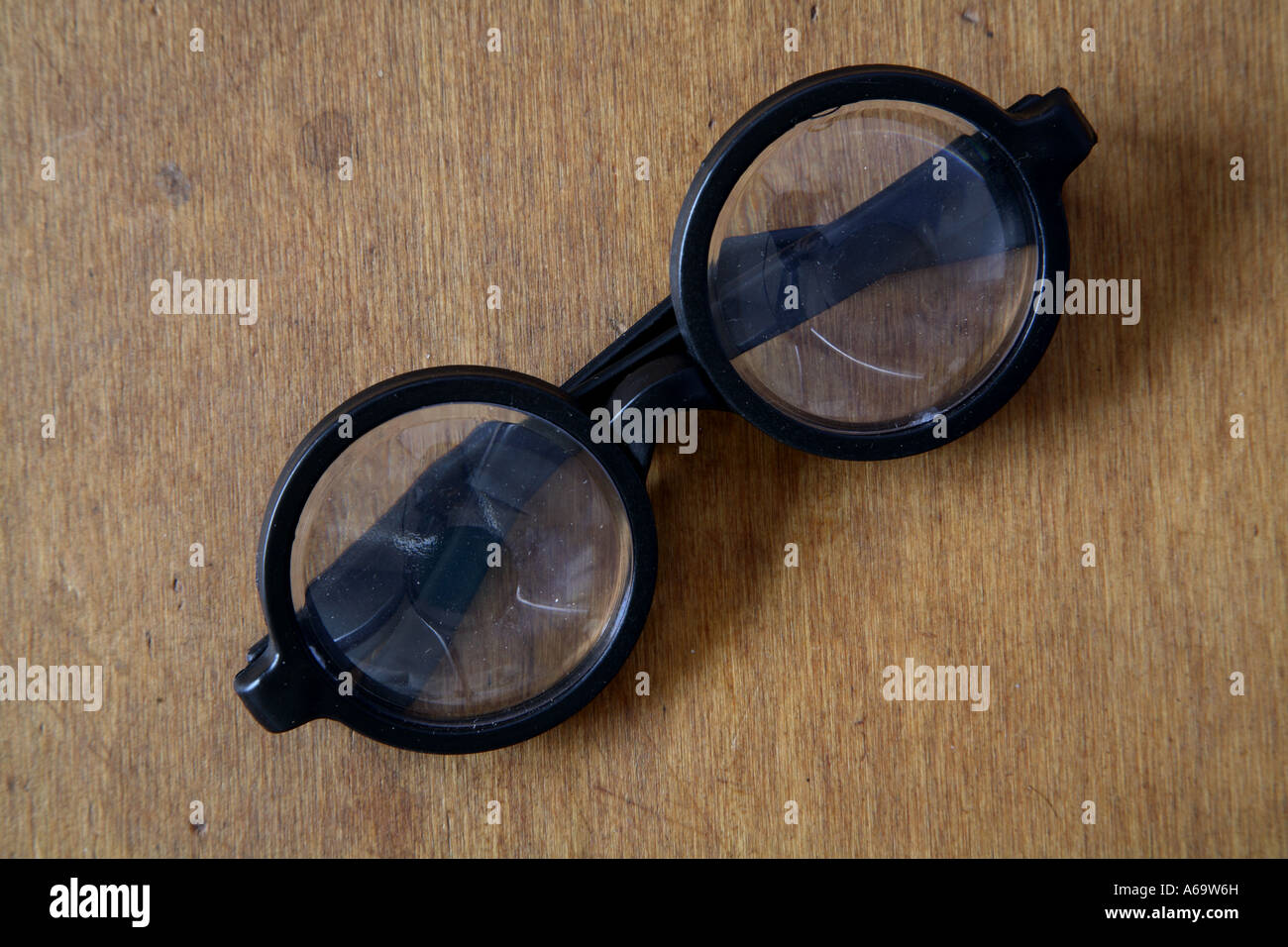 plastic reading glasses on wood Stock Photo - Alamy
