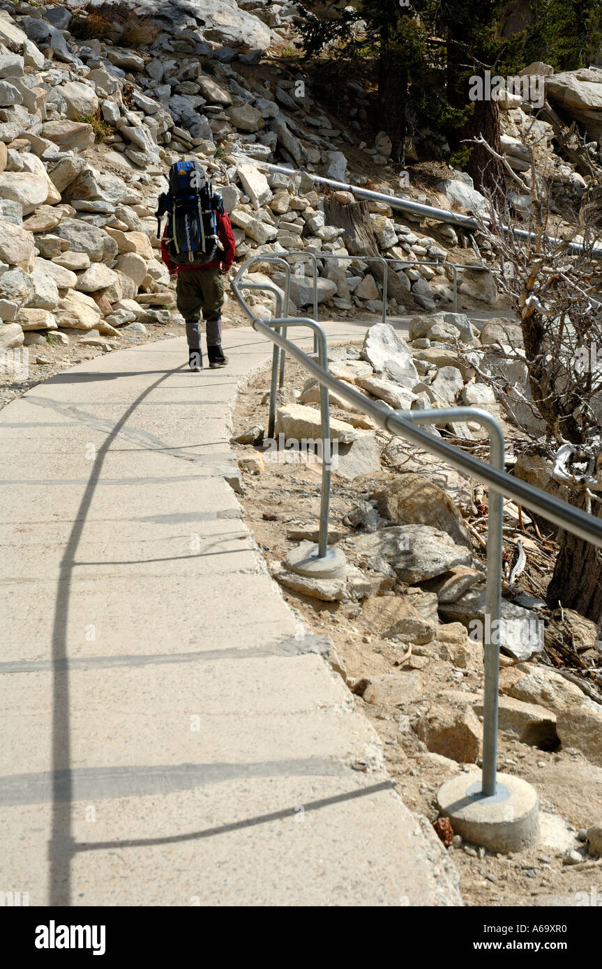 Backpacker leaving mountain resort to enter the forest trail Stock ...