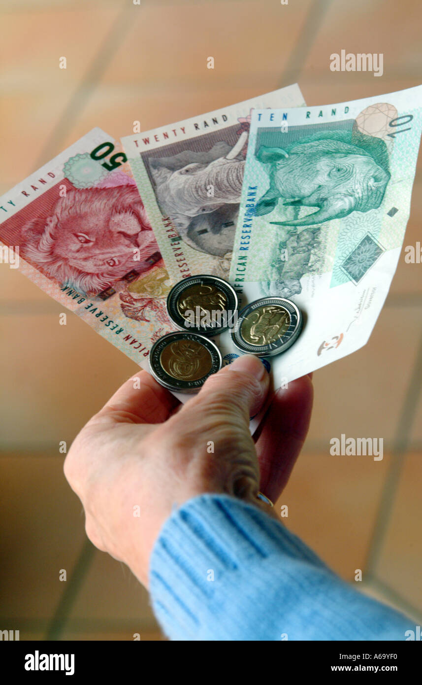 hand holds new currency for South Africa Rand banknotes and coins Stock ...
