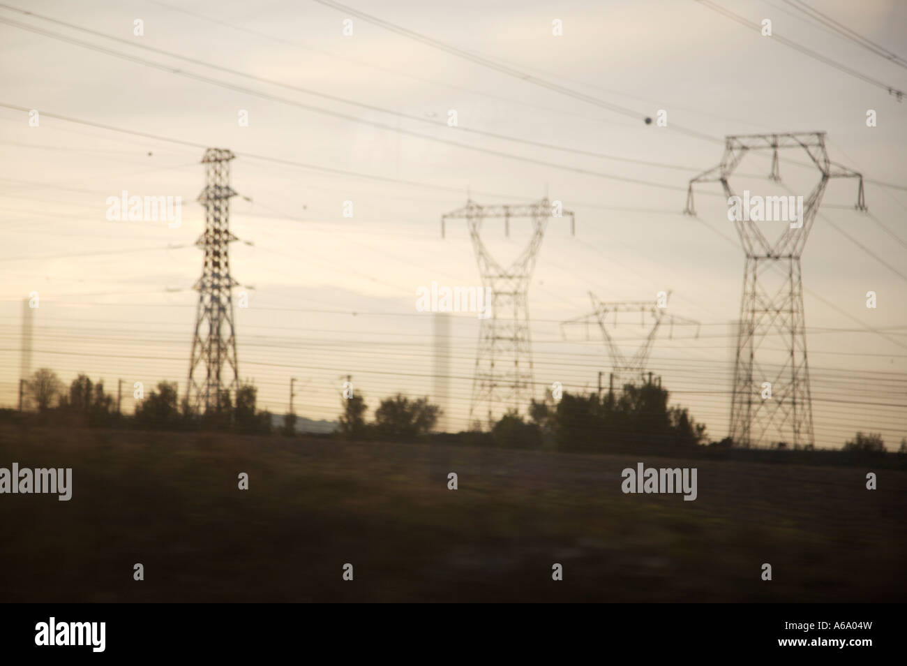 electricity pylons at sunset from the eurostar train in the french ...