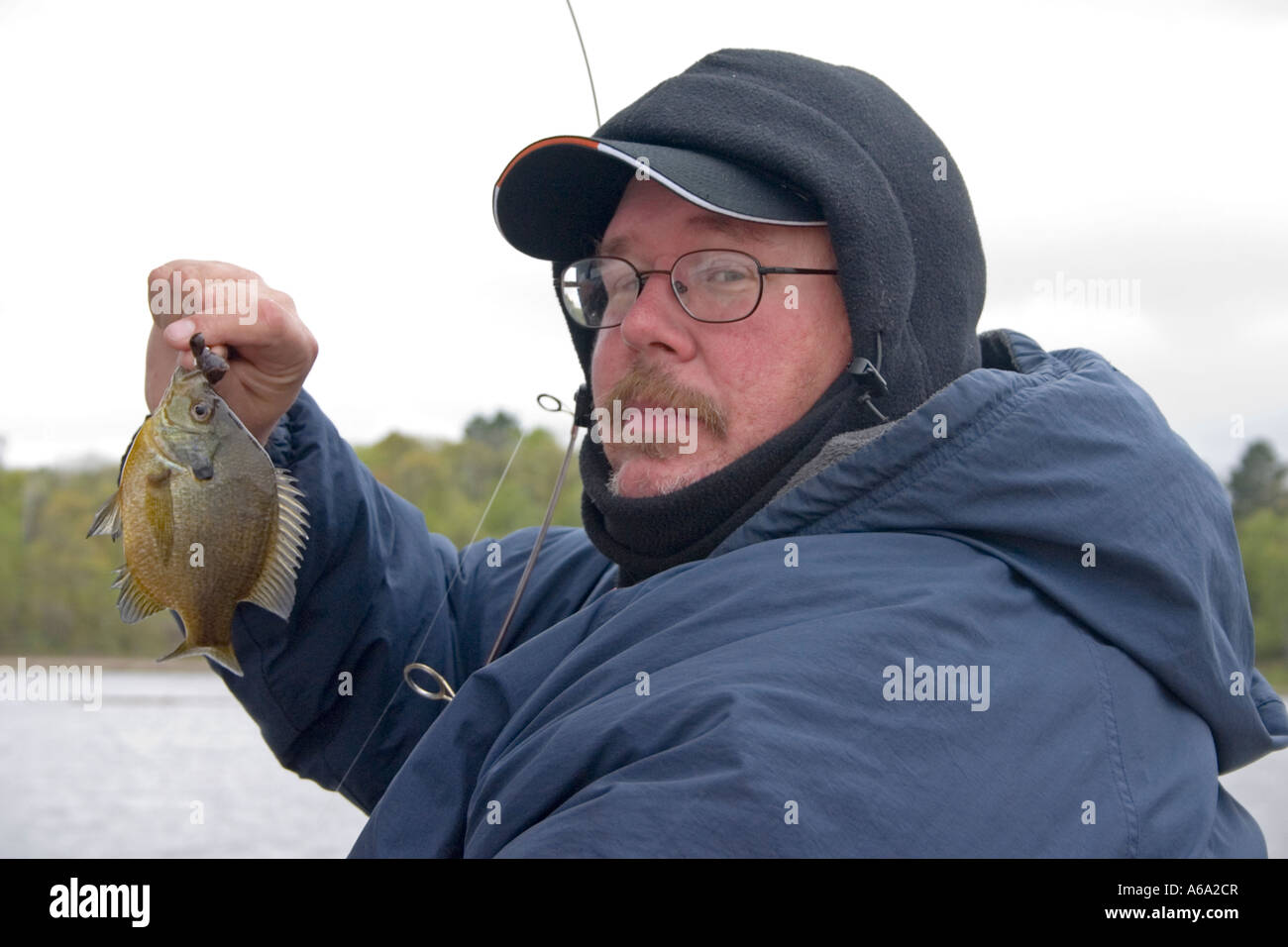 Fisherman proud with his sunfish catch practices the annual rite of the ...