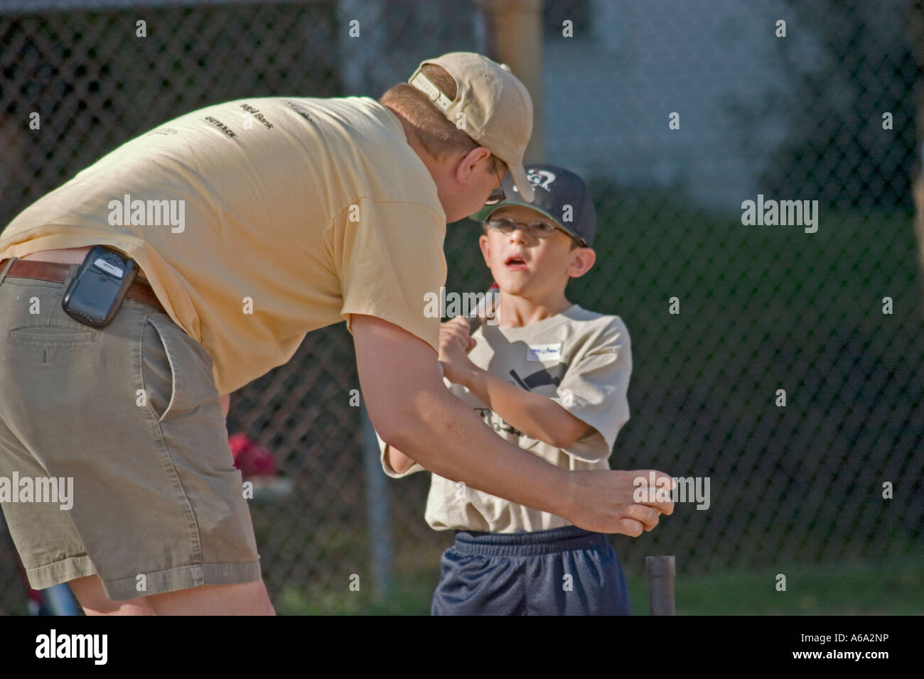 T-ball batter getting advice from coach age 7 and 32. Groveland School ...