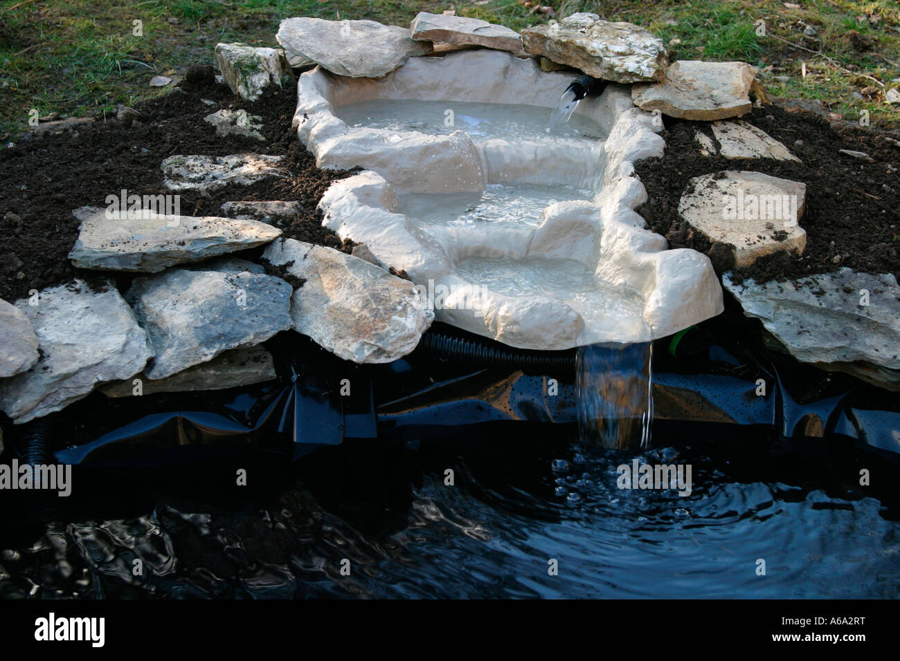BUILDING A WATERFALL STEP 16 -TROUGH IN POSITION Stock Photo - Alamy