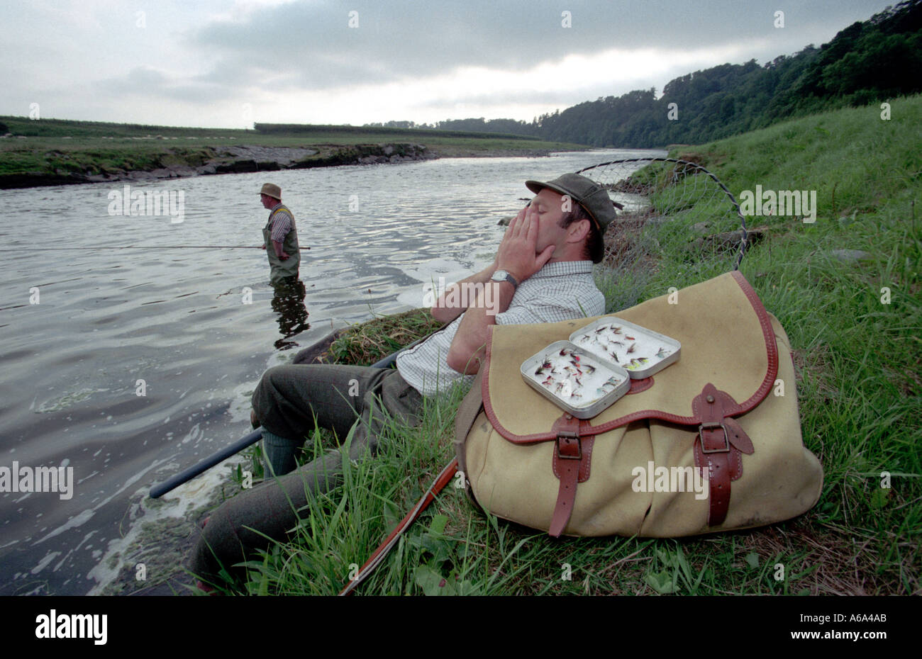 Salmon fishing on river Tweed with Ghillie on riverbank Stock Photo - Alamy