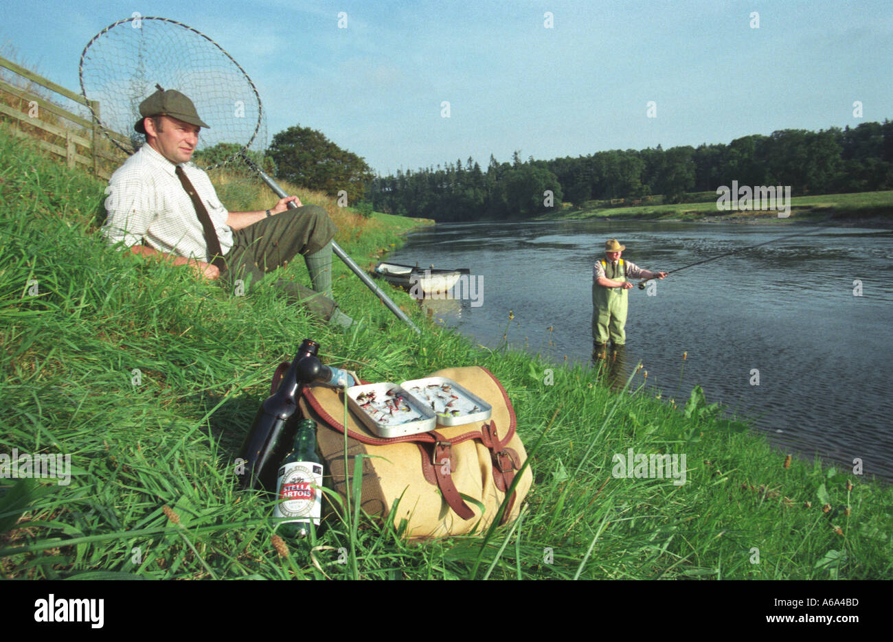 Salmon fishing on river Tweed with Ghillie on riverbank Stock Photo - Alamy