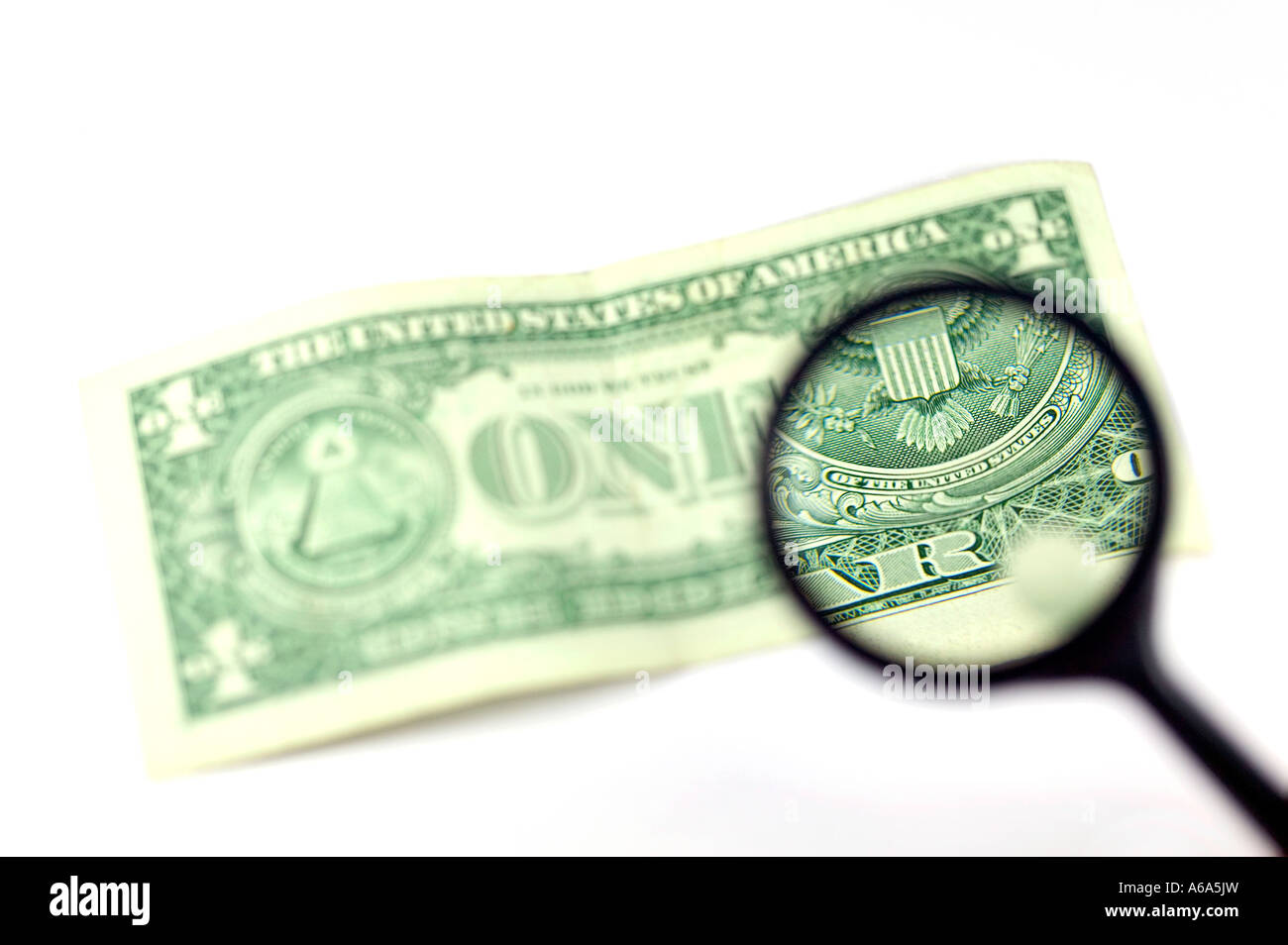 View through a magnifying glass the back of a one dollar note isolated ...