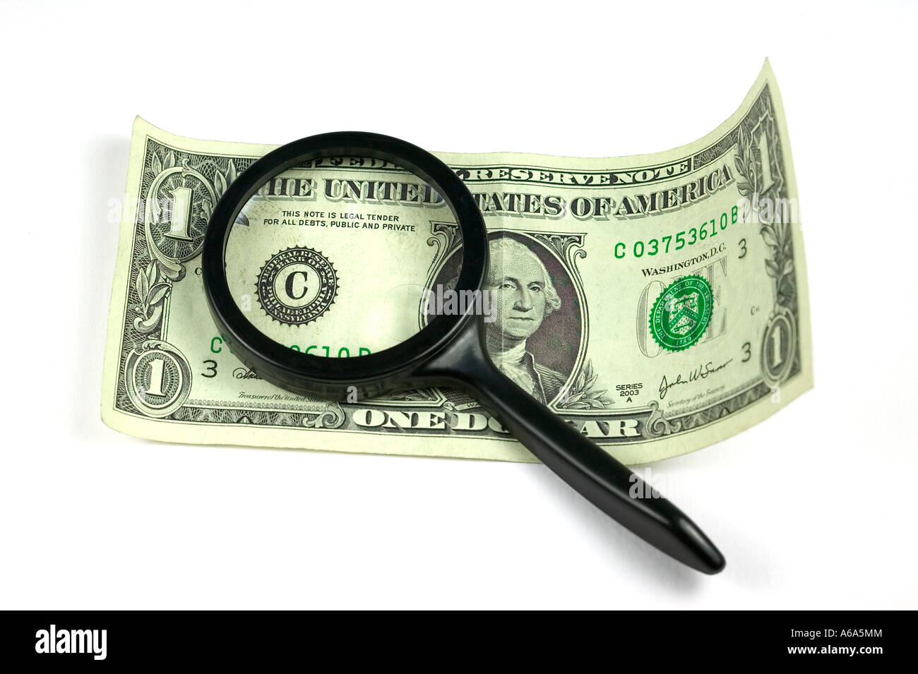 Magnifying glass on top of a dollar bill isolated on white Stock Photo ...