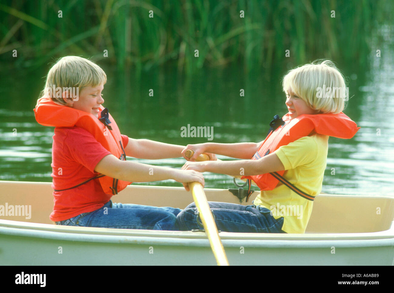 small boy and girl rowing boat Stock Photo - Alamy