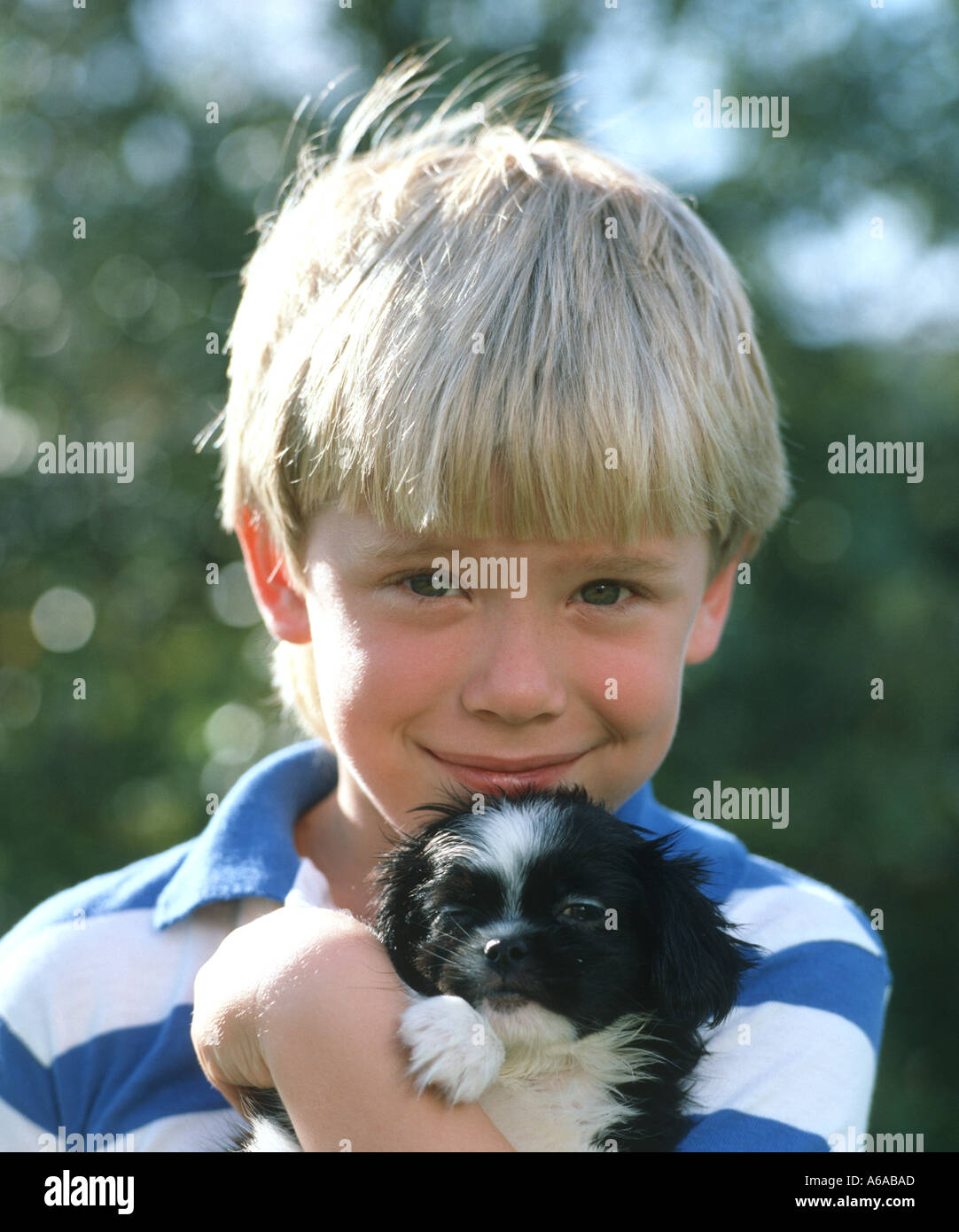 smiling boy with puppy Stock Photo - Alamy