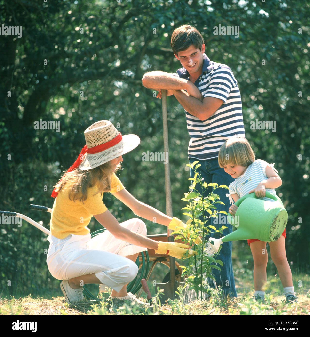 family of three working in garden Stock Photo - Alamy