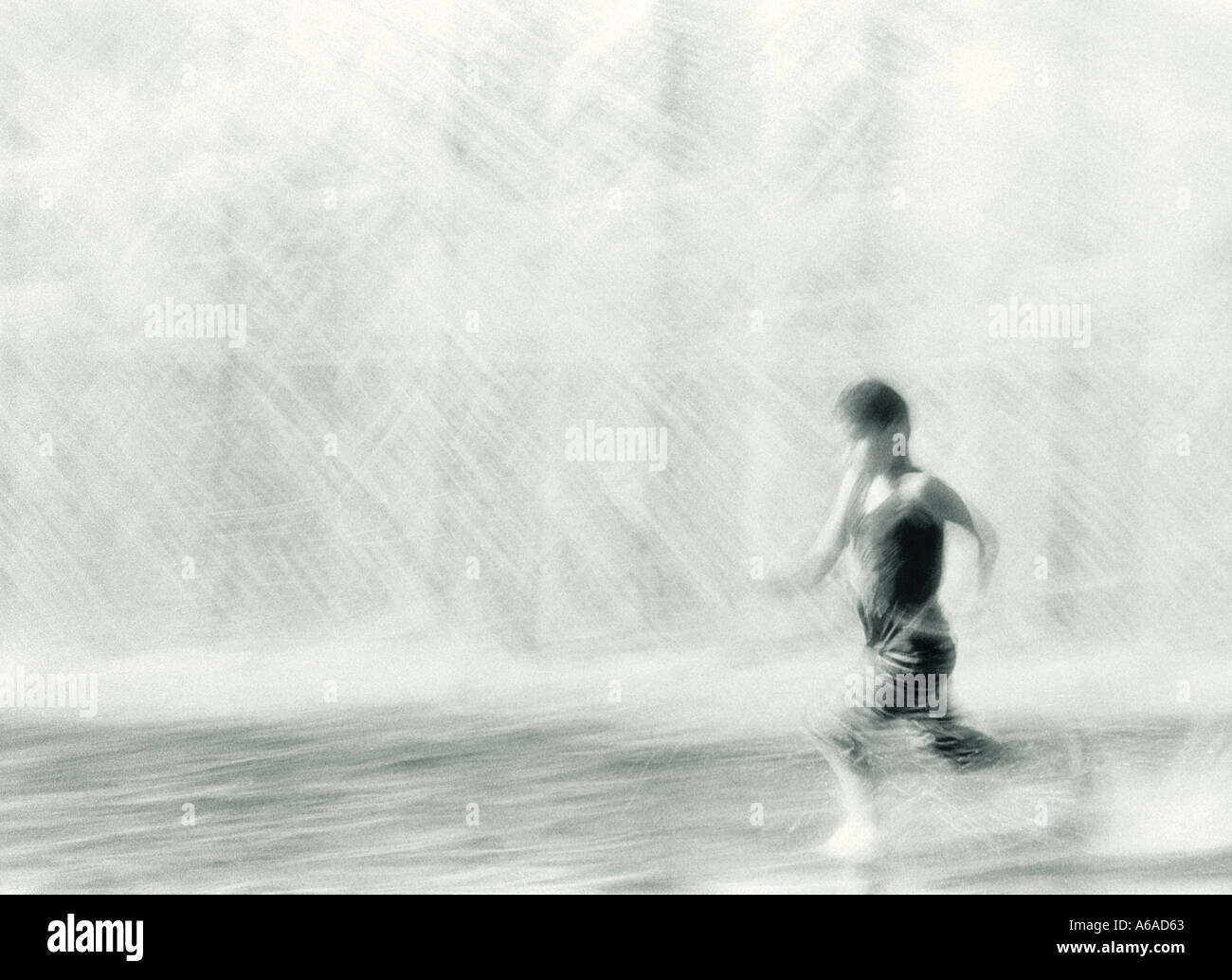 Young Boy Running In Water Stock Photo - Alamy