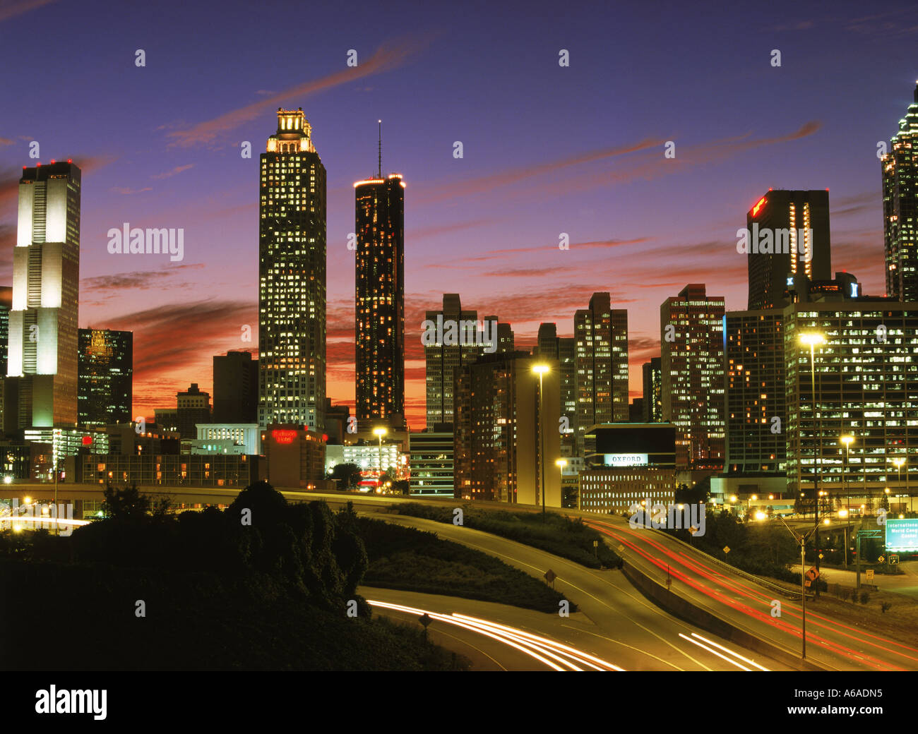 Highways leading into and out of Atlanta at dusk under city skyline ...
