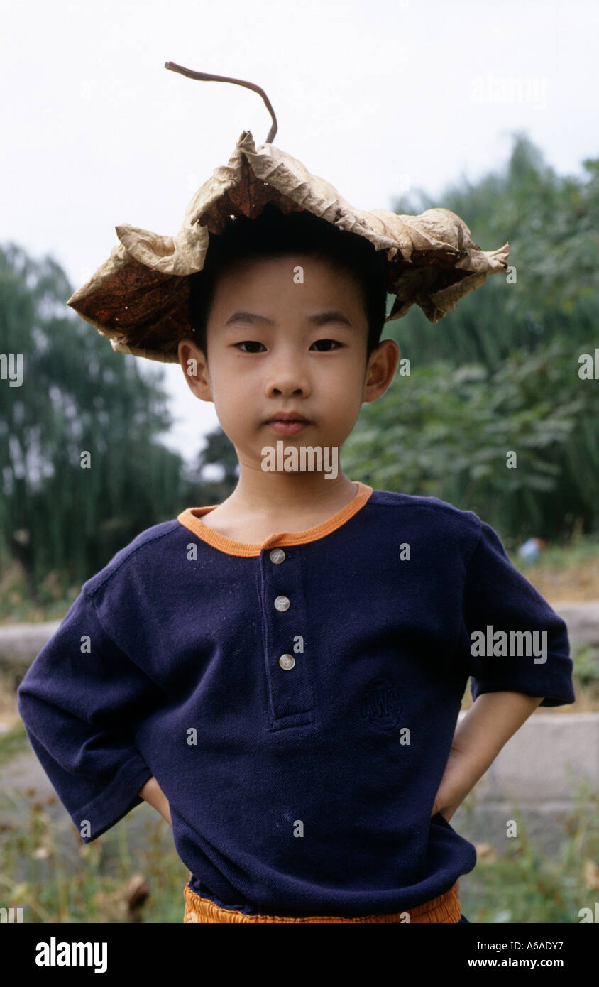 Chinese boy with a lotus leaf in Beijing Stock Photo - Alamy