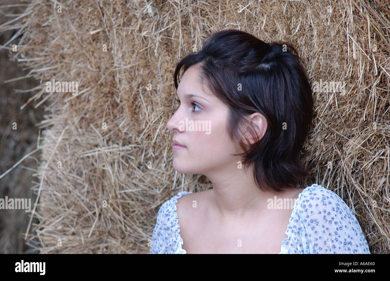 Teenage Girl Sitting In Haystack Stock Photo - Alamy