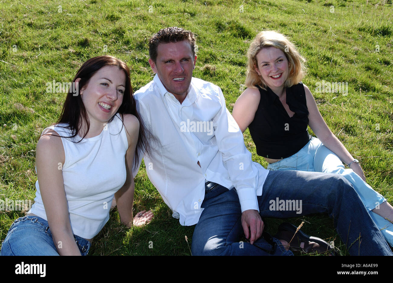3 friends sitting outside talking during summer Stock Photo - Alamy