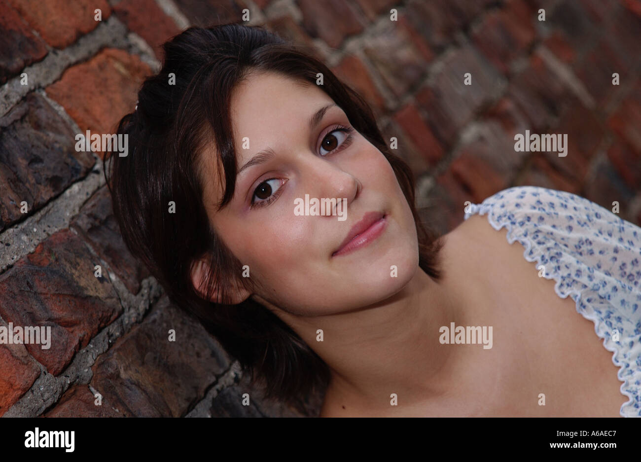 Teenage Girl Standing Against Brick Wall Stock Photo - Alamy