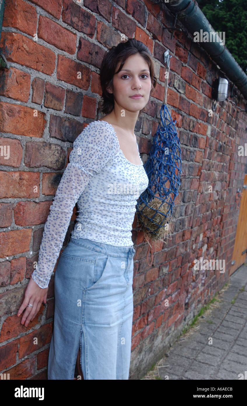 Teenage Girl Standing Against Brick Wall Stock Photo - Alamy